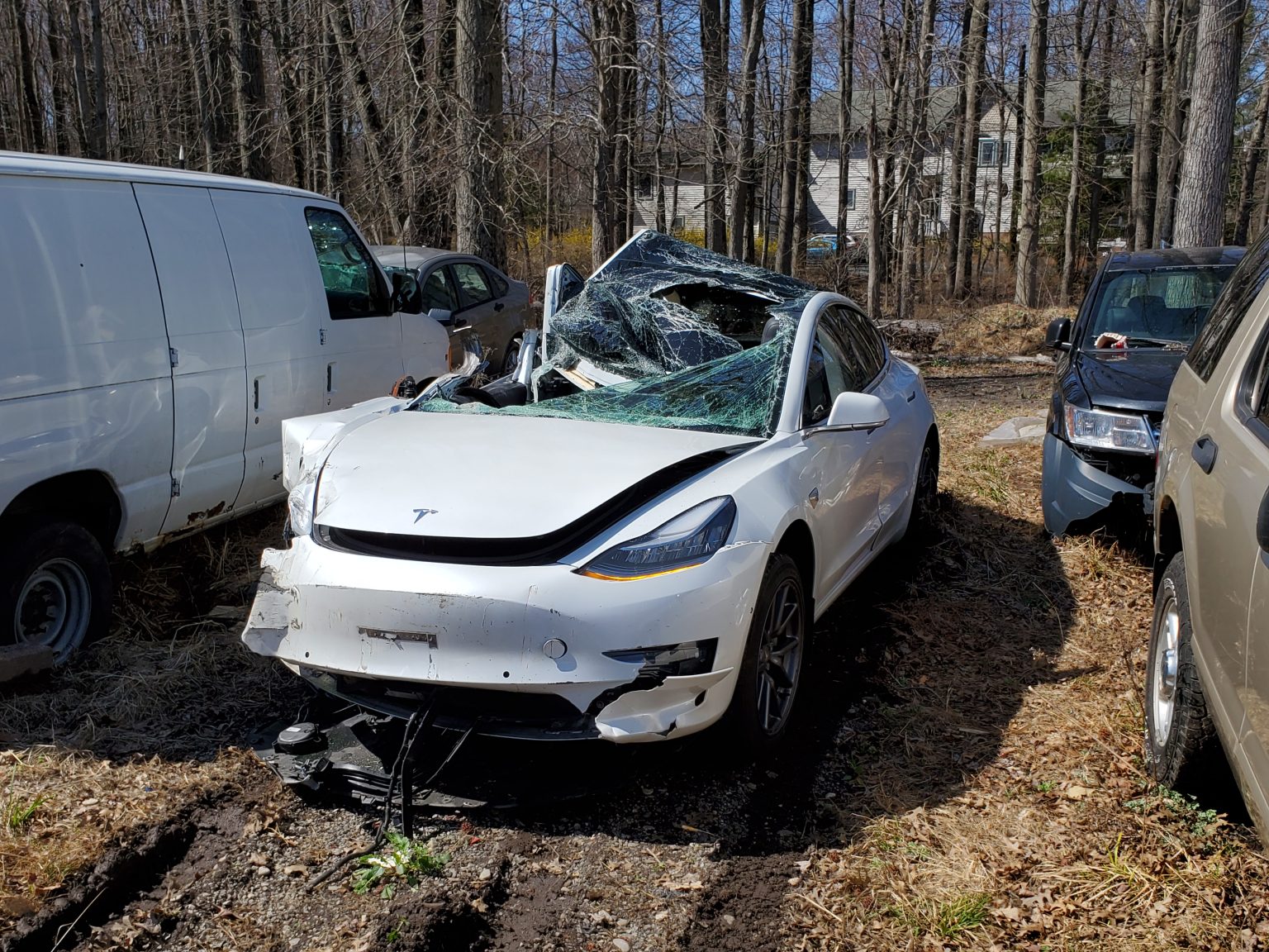 Tesla Model 3 crashes into semi trailer, driver survives roof being ...